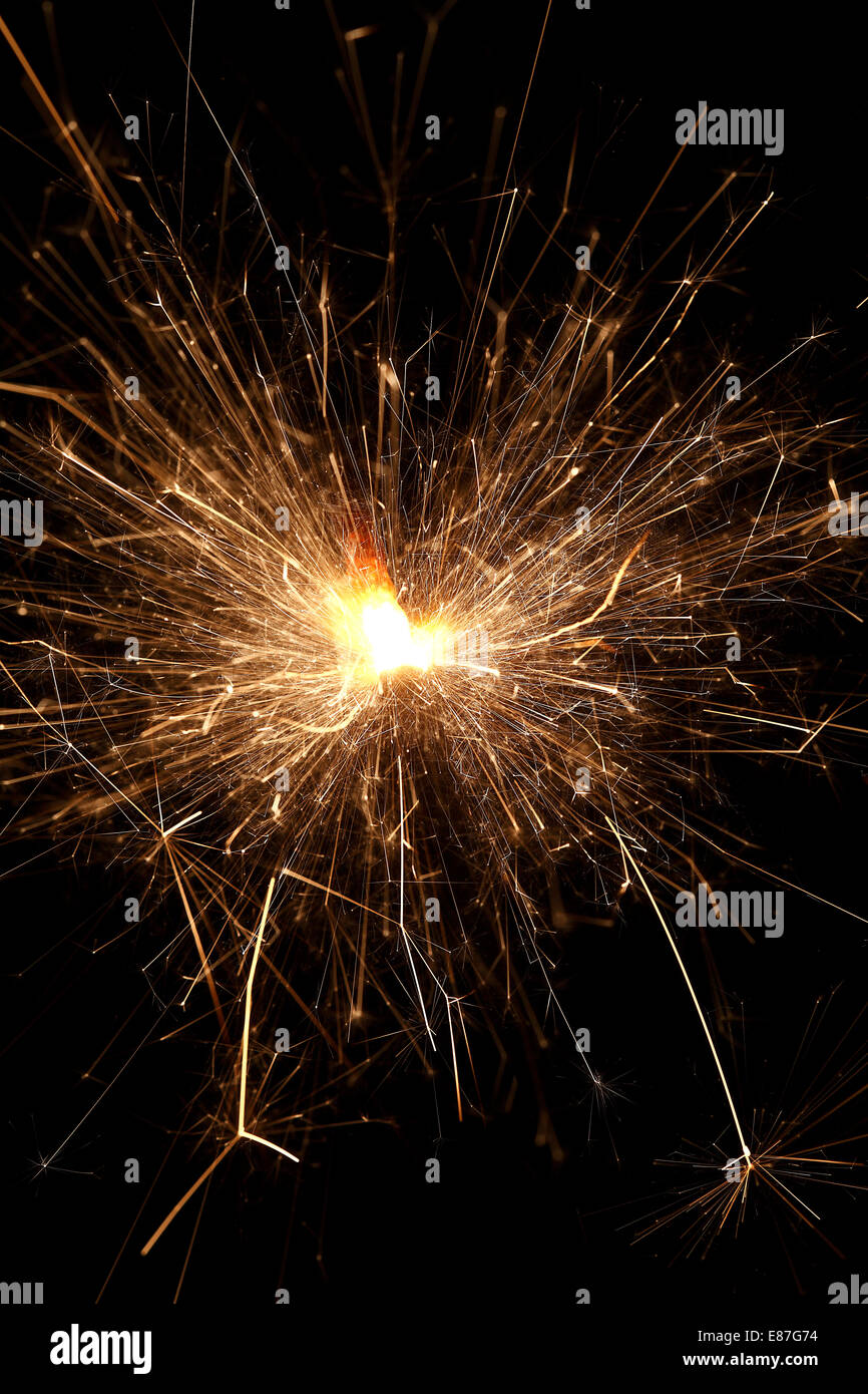 Burning sparkler in front of a black background Stock Photo - Alamy