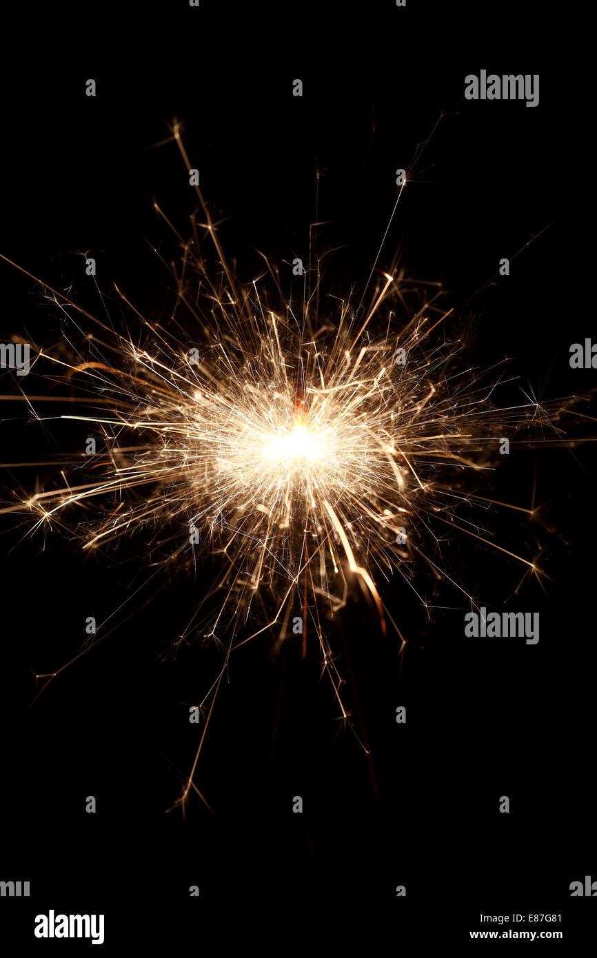 Burning sparkler in front of a black background Stock Photo - Alamy