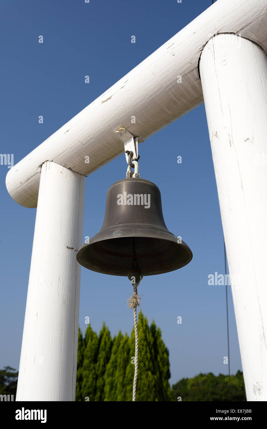 Bronze bell hanging on wooden pillar Stock Photo - Alamy