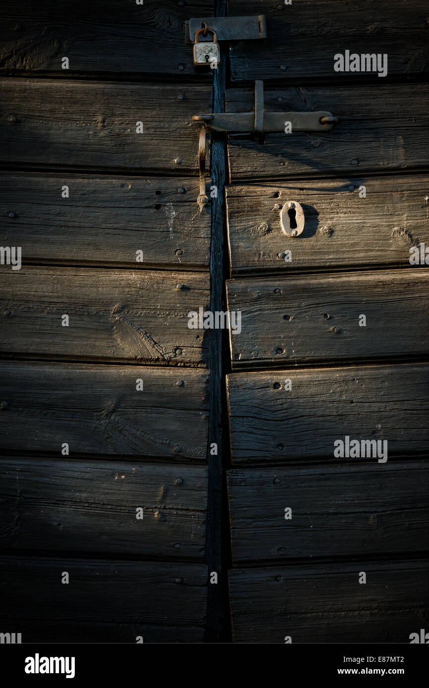 Old lock on barn door in afternoon light (vertical Stock Photo - Alamy