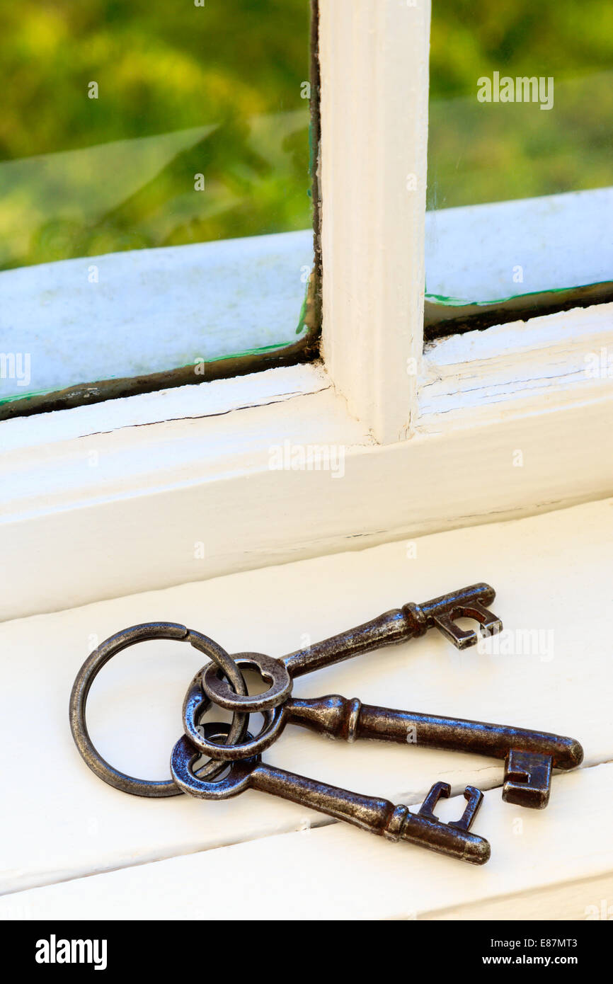 Old keys on windowsill by window Stock Photo - Alamy