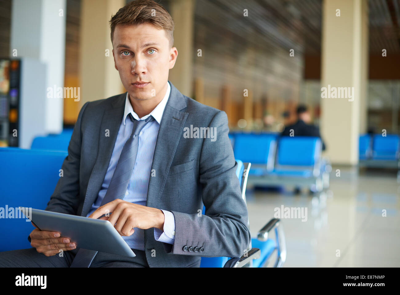 Businesswoman using touchpad looking camera hi-res stock photography ...
