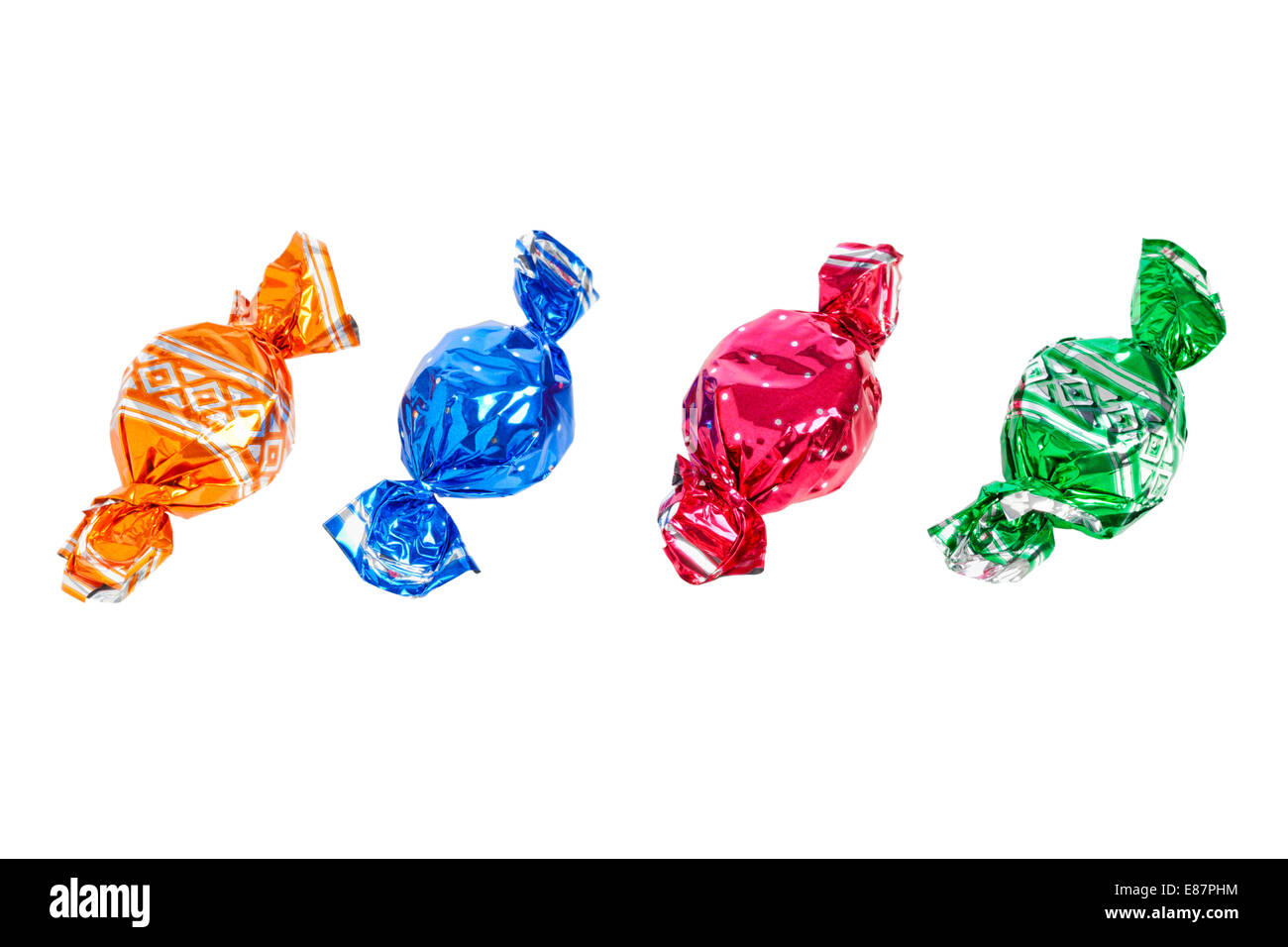 Four candies wrapped in colorful foil isolated on white Stock Photo - Alamy