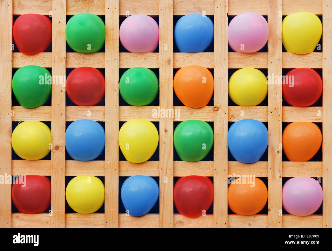 Color balloons in wooden cells Stock Photo - Alamy