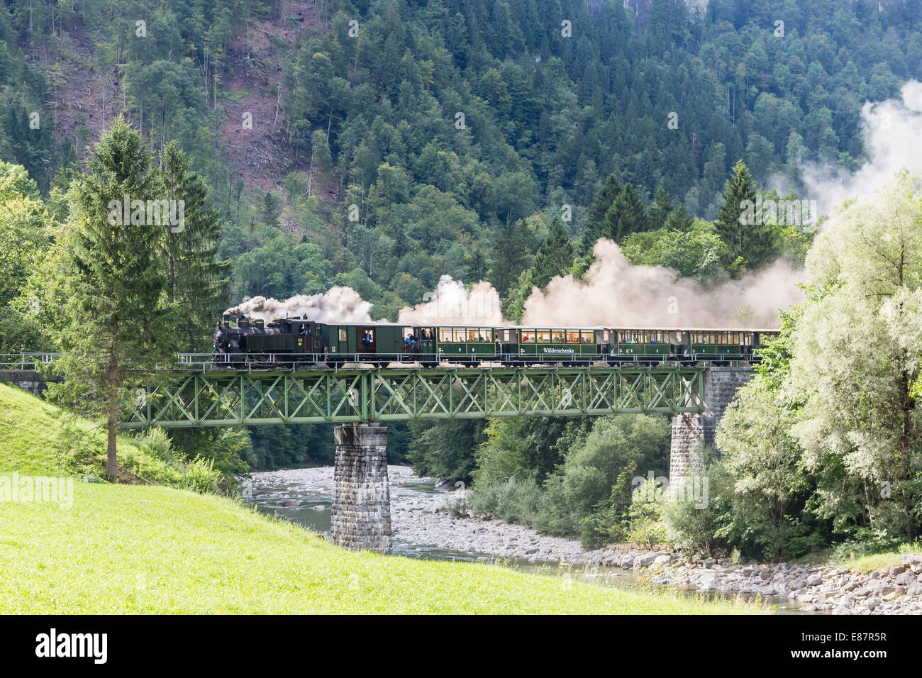 Bregenz Forest Railway with steam locomotive crossing steel bridge ...