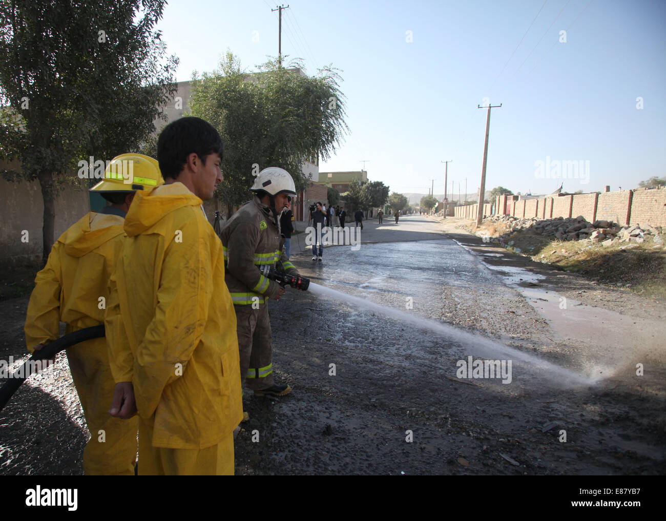 Kabul, Afghanistan. 2nd Oct, 2014. Afghan fire fighters wash a road ...