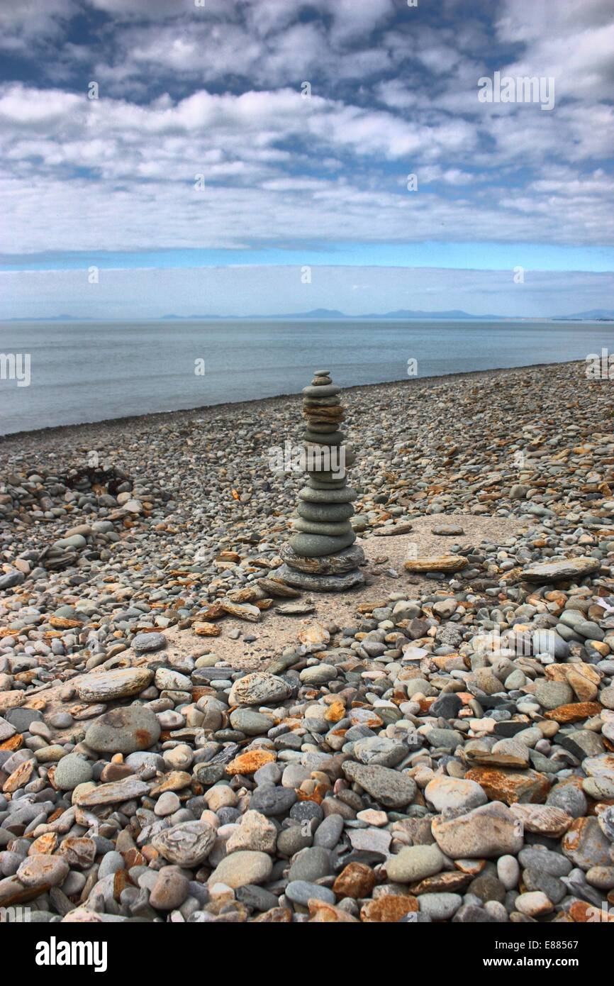 stones balancing on top of each to make a tower on a beach Stock Photo ...