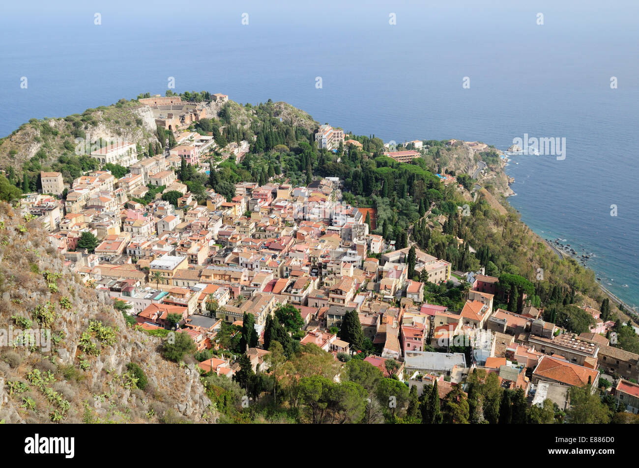 c Taormina perched on a cliff overlooking the Ionian Sea on the East ...