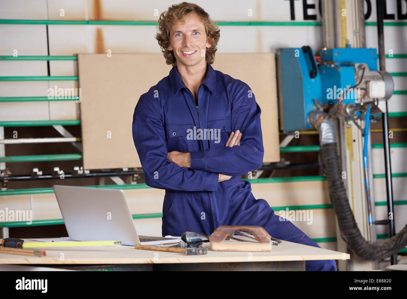 Confident Carpenter With Arms Crossed In Workshop Stock Photo - Alamy