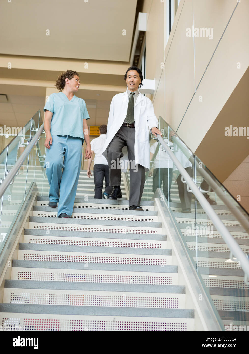 Doctor male walking down steps hi-res stock photography and images - Alamy