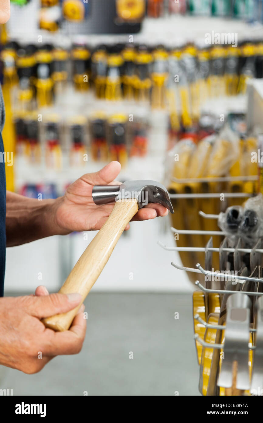 Salesman Holding Hammer In Hardware Store Stock Photo - Alamy