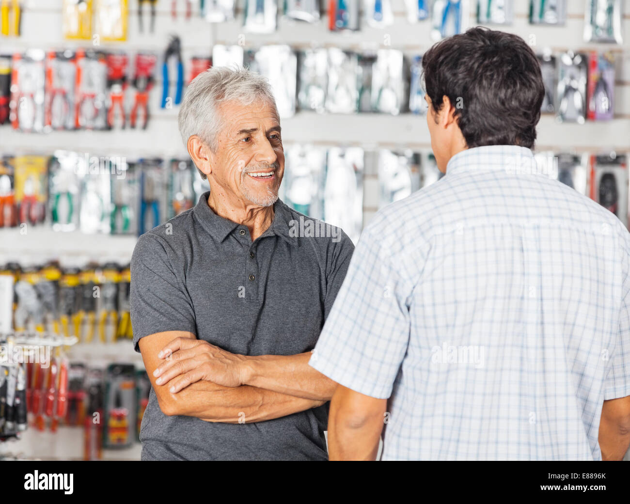Man Conserving With Son In Hardware Store Stock Photo - Alamy