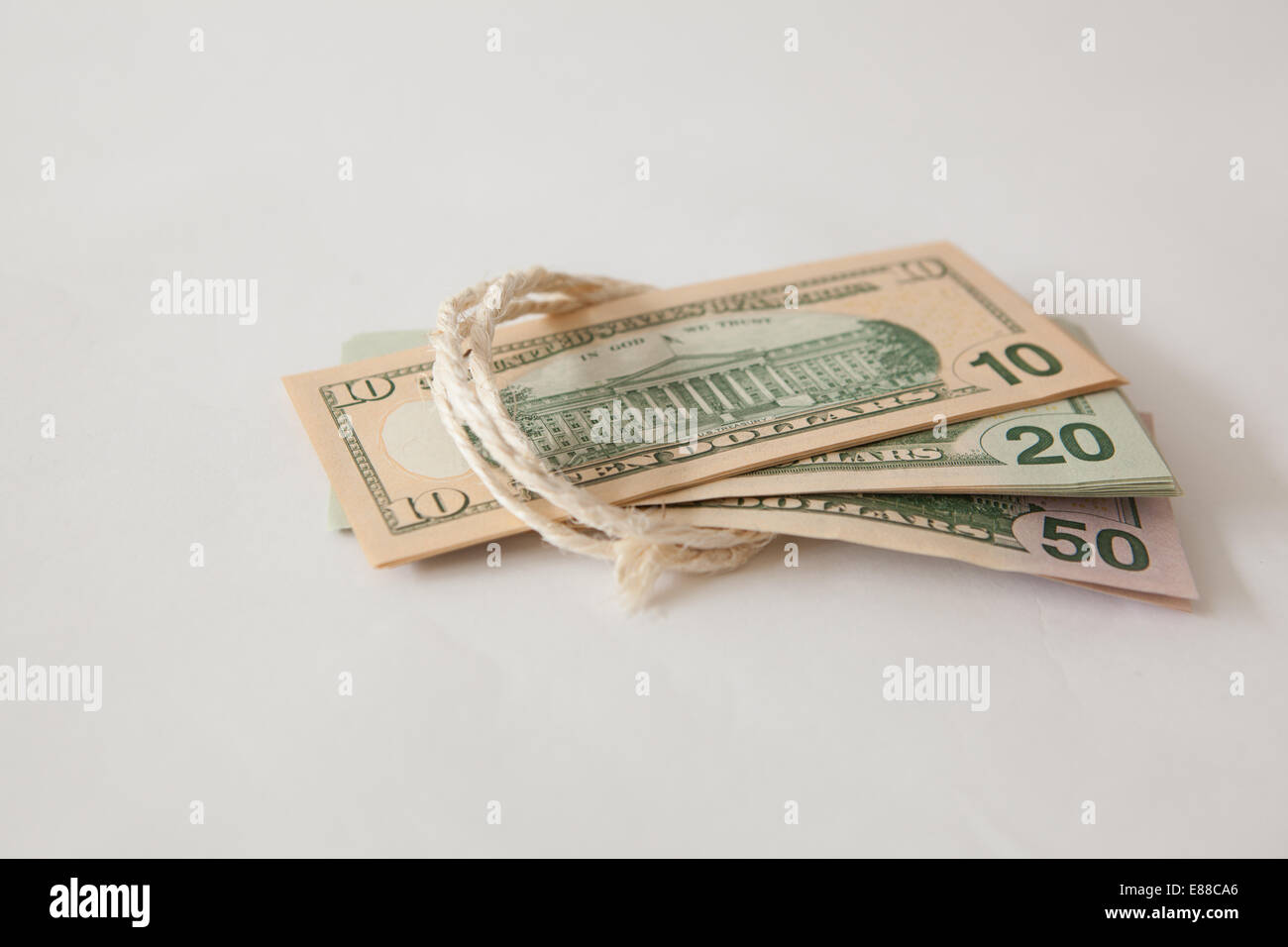 dollars tied up with string Stock Photo - Alamy