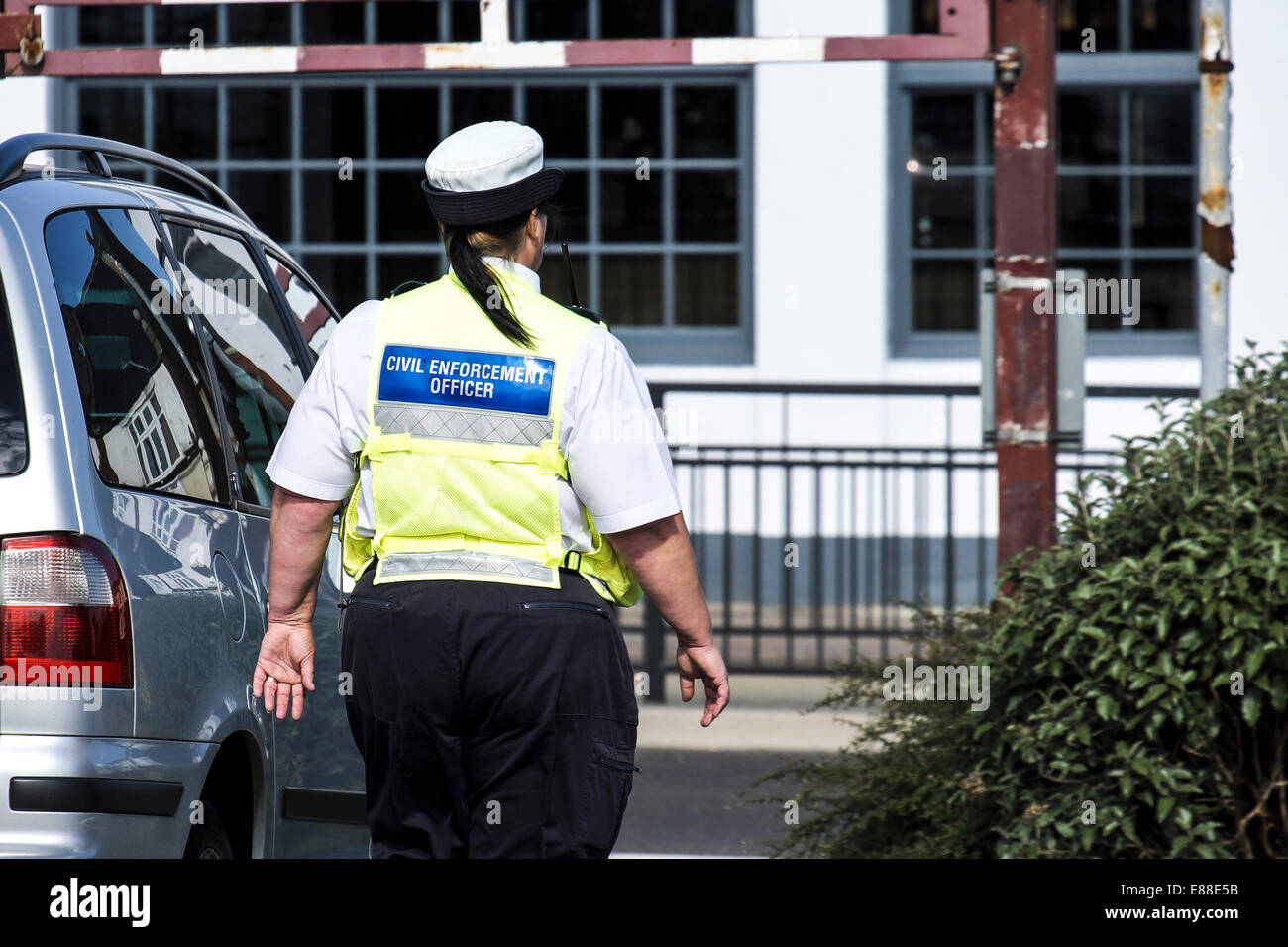 A civil enforcement officer patrolling a car park in Southend Stock ...