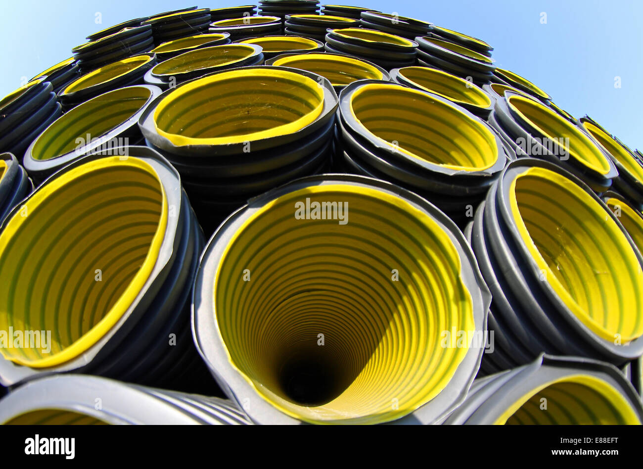 yellow corrugated pipes in a roadworks for laying optical fiber for ...