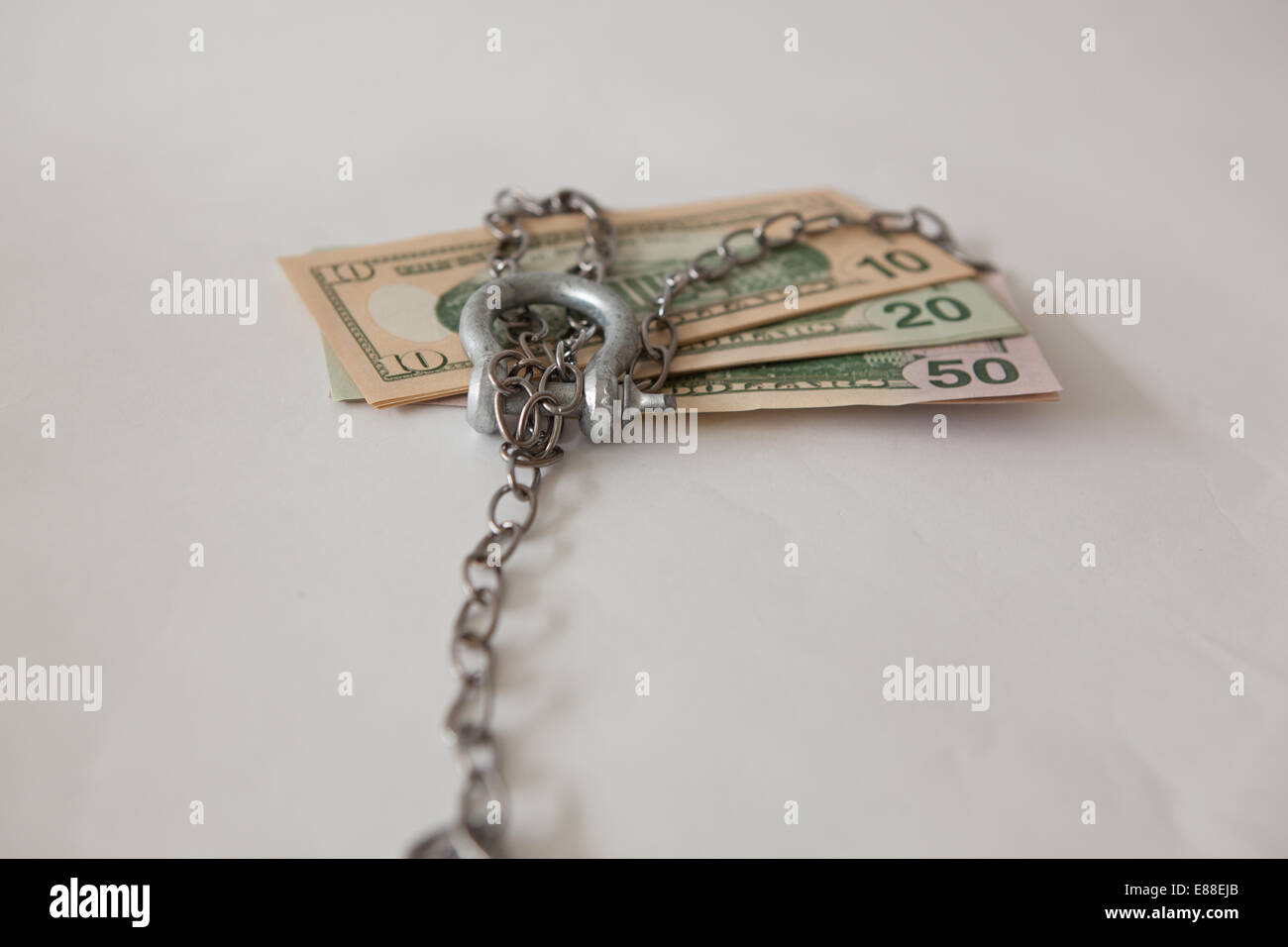 dollars large lock bolt tied up silver chain Stock Photo - Alamy