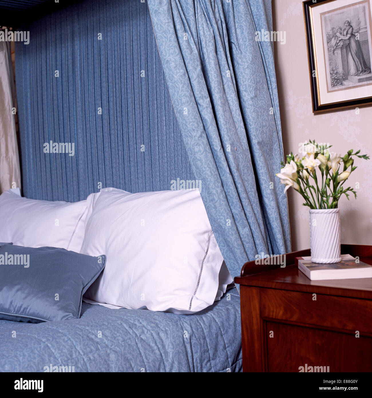 White pillows on half tester bed with blue drapes and quilt Stock Photo ...