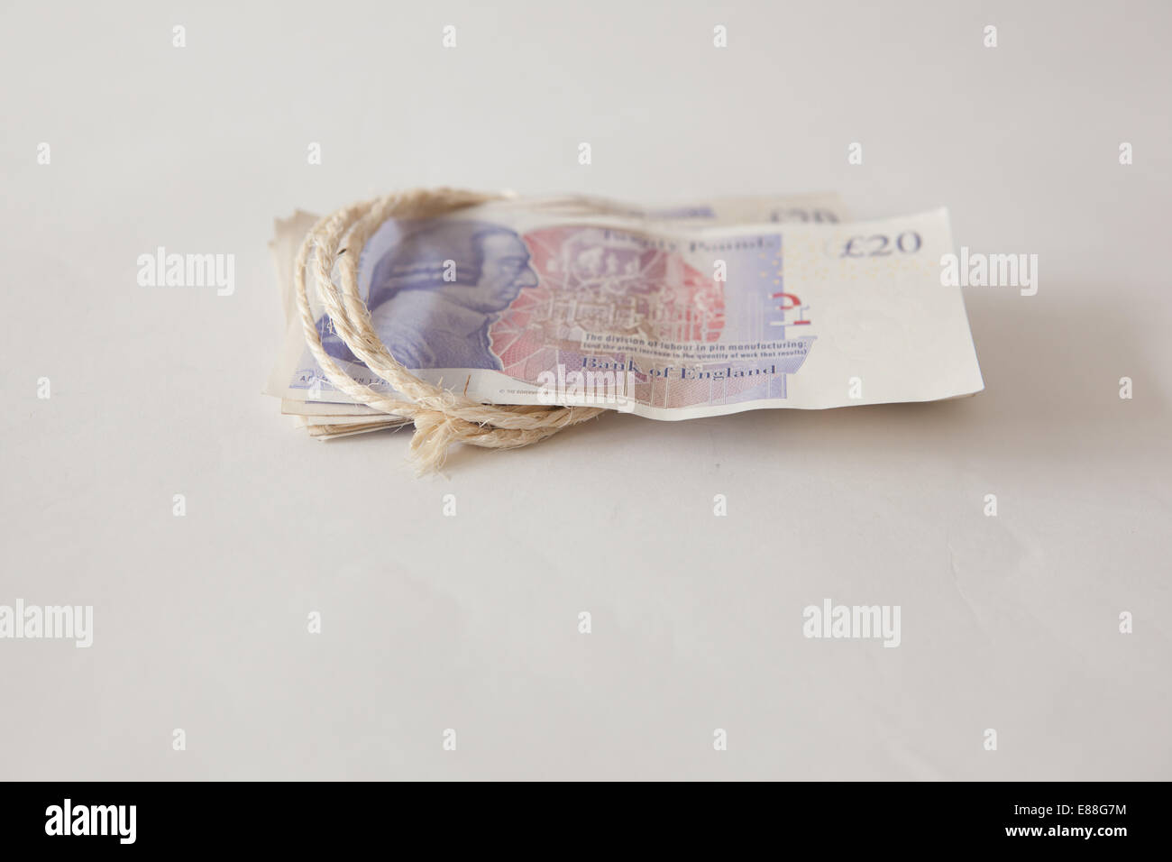pounds tied up with string Stock Photo - Alamy