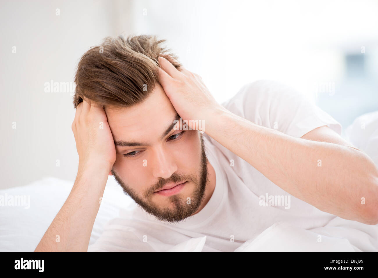 Young man waking up Stock Photo - Alamy