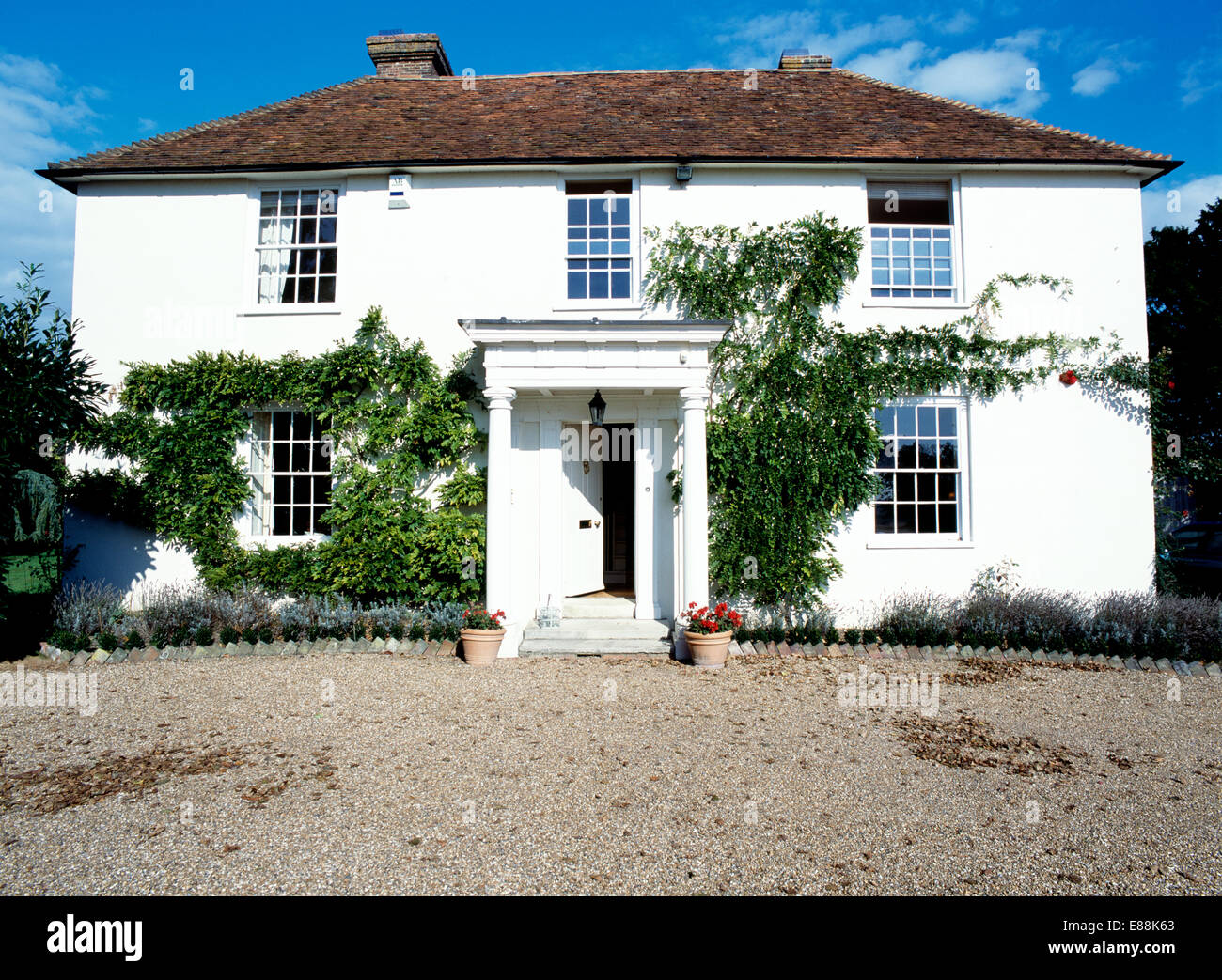 Pillared porch on detached white Victorian country house with green ...