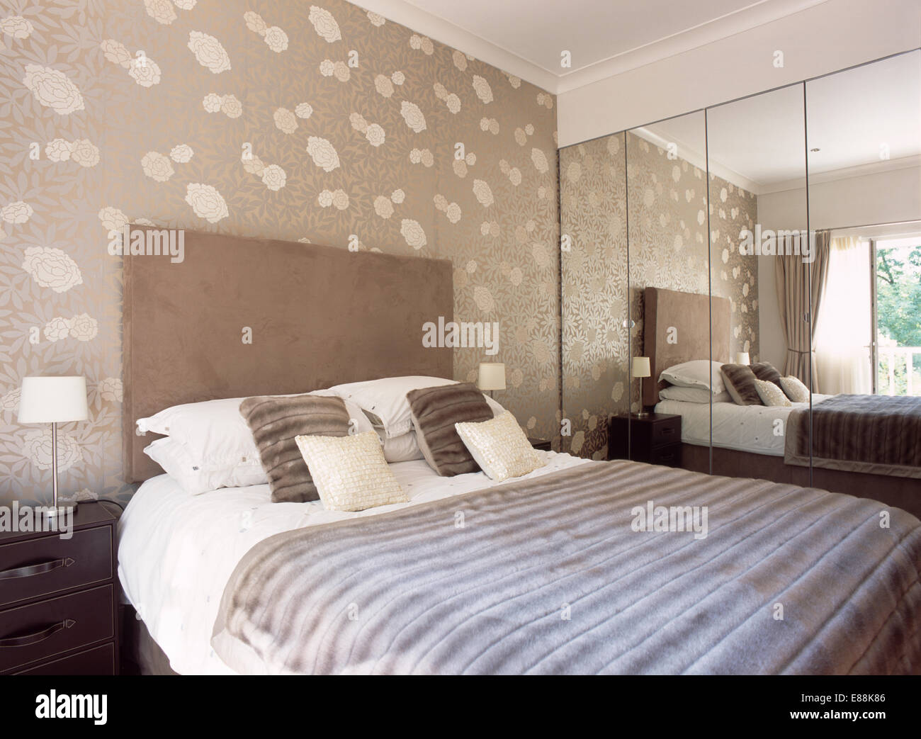 Suede headboard on bed with faux fur throw in modern bedroom with ...