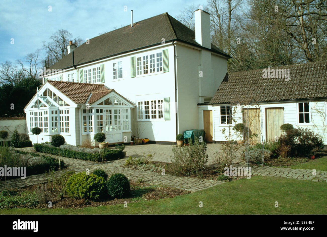 Conservatory extension on white country house built in the fifties ...