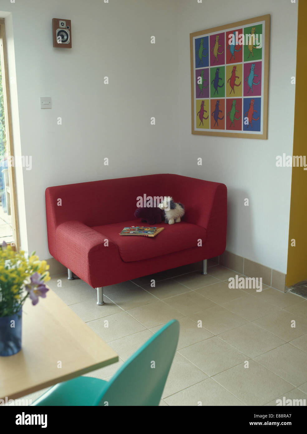 Red armchair in corner of modern dining room extension Stock Photo - Alamy
