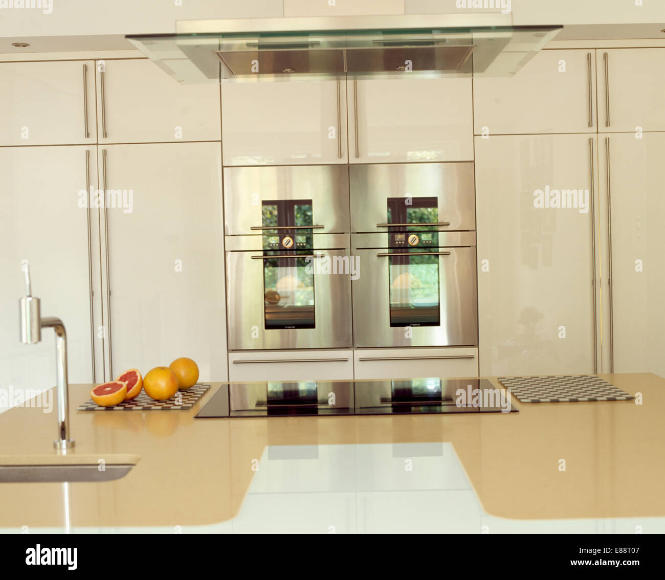 Double oven in modern kitchen with hob built into island unit Stock ...