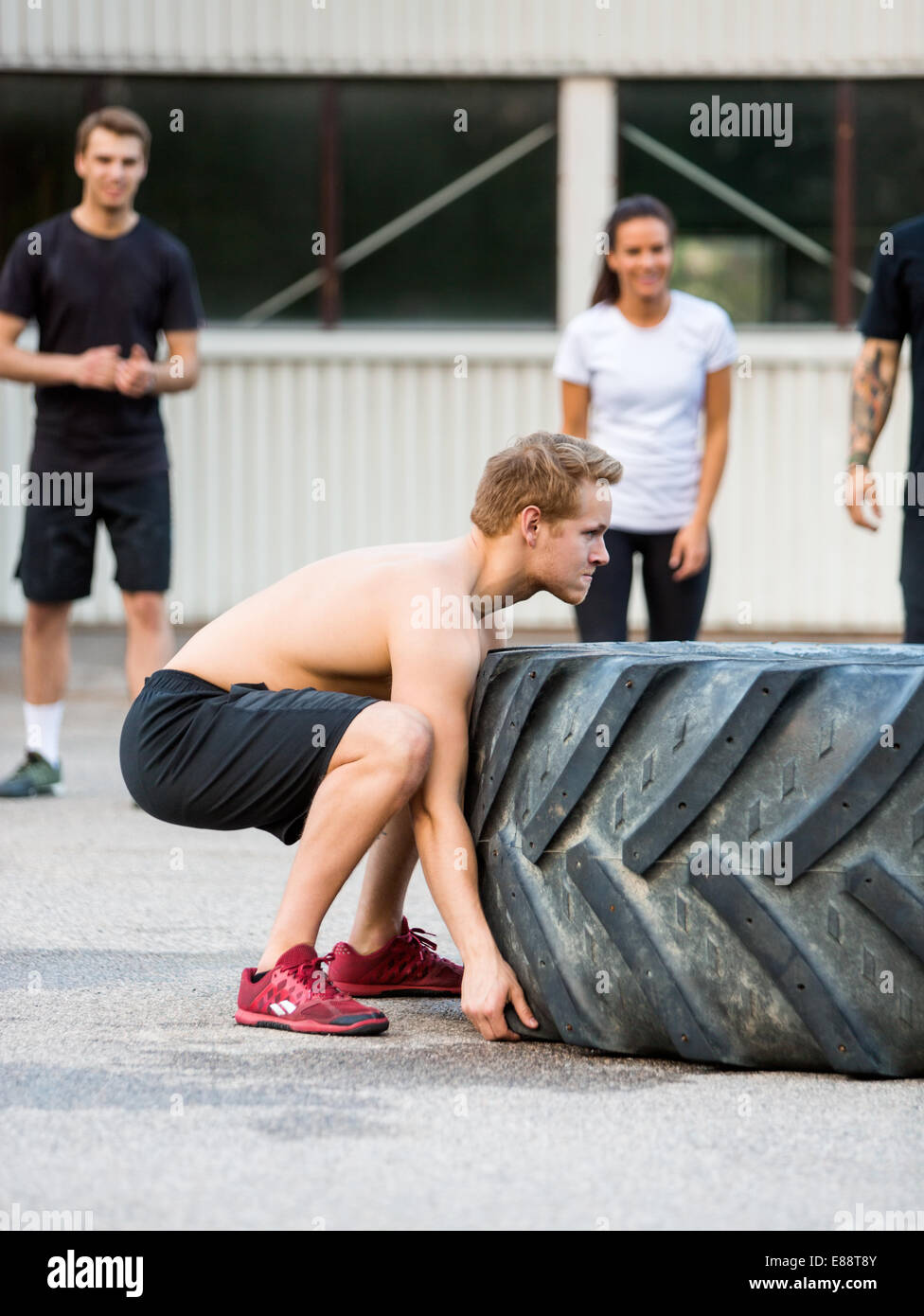 Male Athlete Flipping Tractor Tire Stock Photo - Alamy