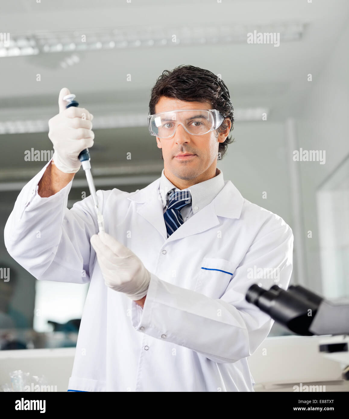 Scientist Filling Solution Into Test Tube Stock Photo - Alamy