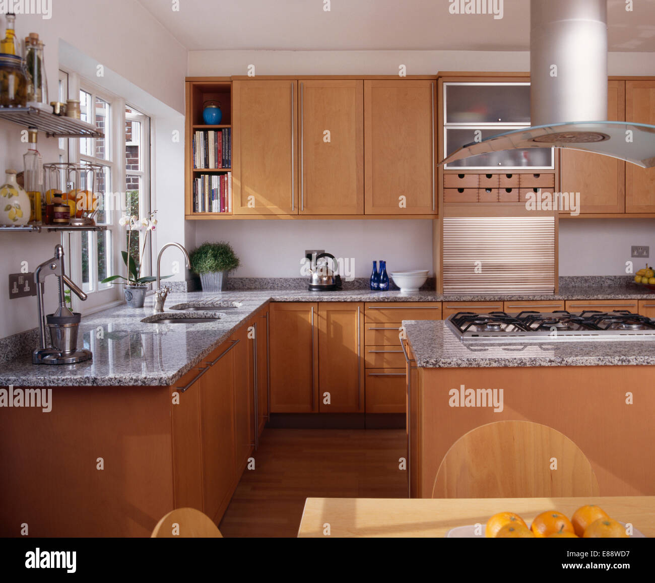 Granite-topped fitted wood units in modern kitchen Stock Photo - Alamy