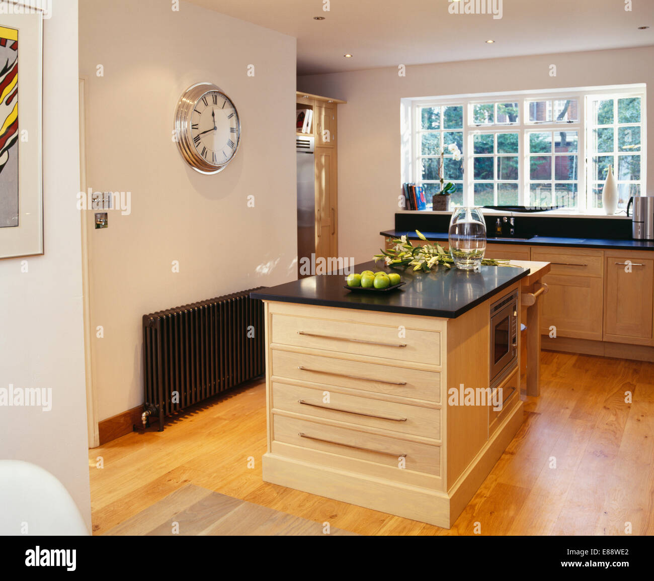 Granite-topped island unit and wooden flooring in modern townhouse ...