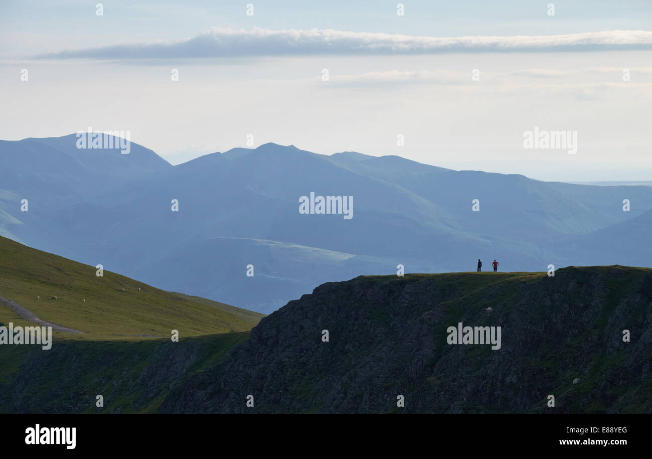 Two hikers taking in the view from the summit of Blencathra in the Lake ...
