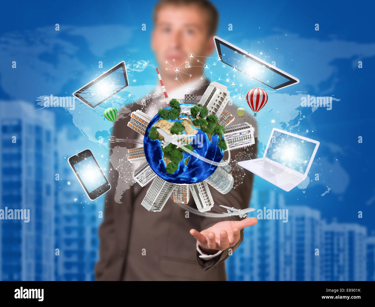 Businessman holding earth with electronics Stock Photo - Alamy