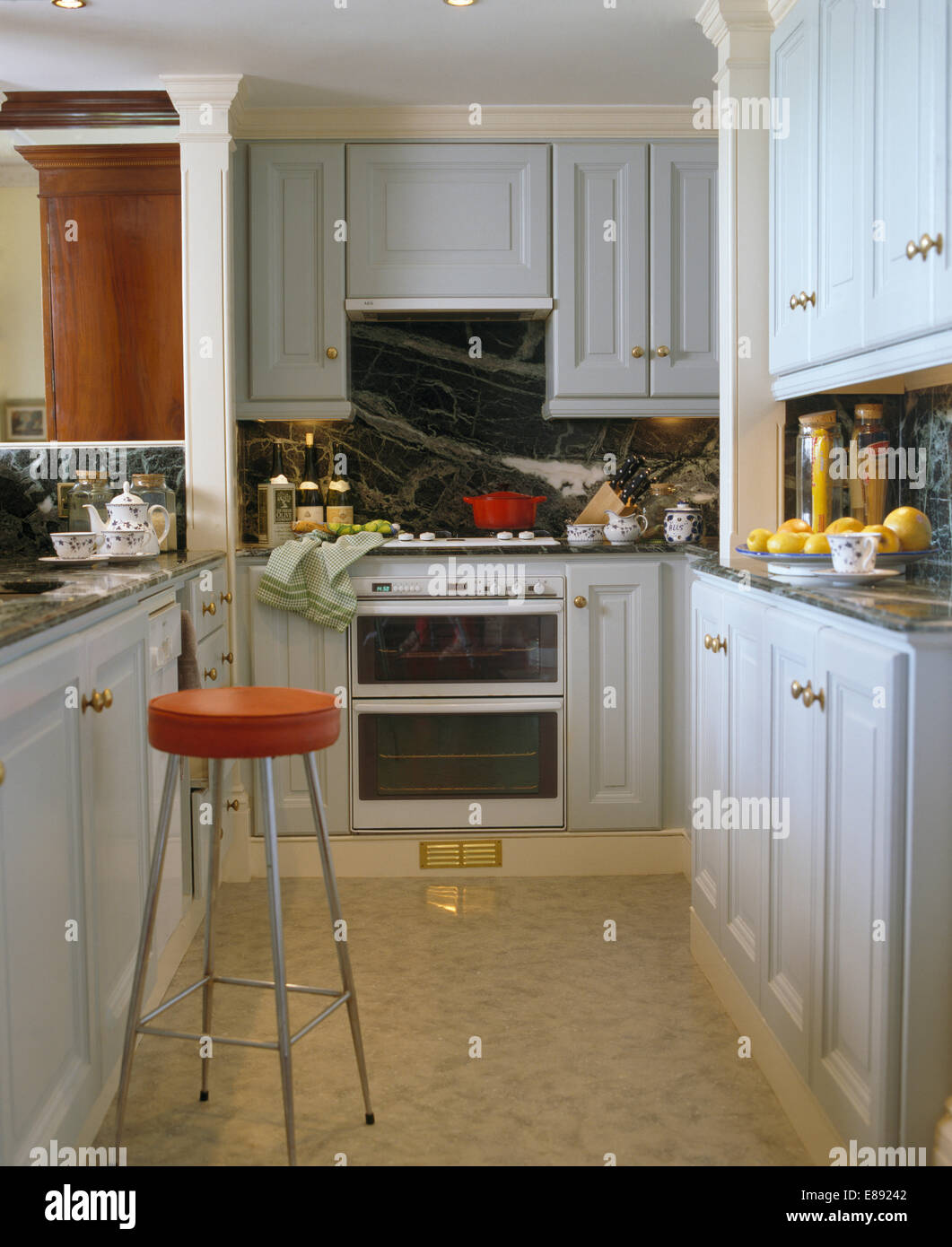 Leather+chrome stool in narrow kitchen with pale grey fitted units ...