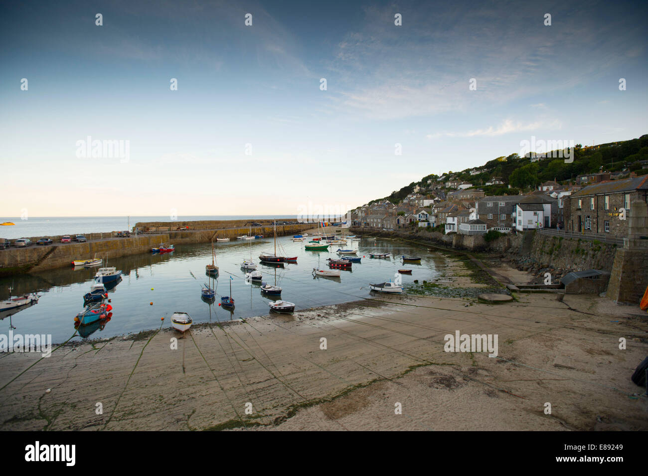 Fishing boats seen in Mousehole harbour in Cornwall at sunset Stock ...