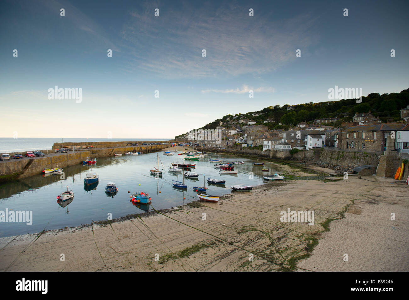 Fishing boats seen in Mousehole harbour in Cornwall at sunset Stock ...