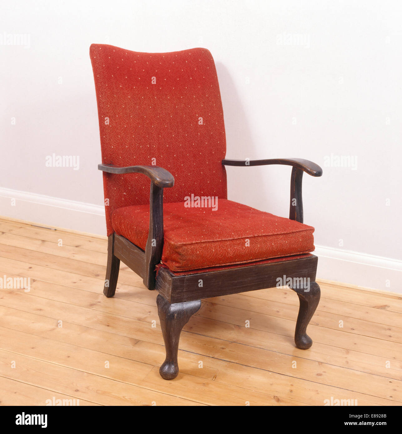 Close-up of old fashioned wood framed chair with red upholstered seat ...