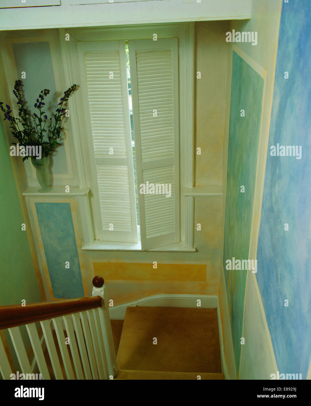 White shutters on window above stairs with pastel blue wlls Stock Photo ...