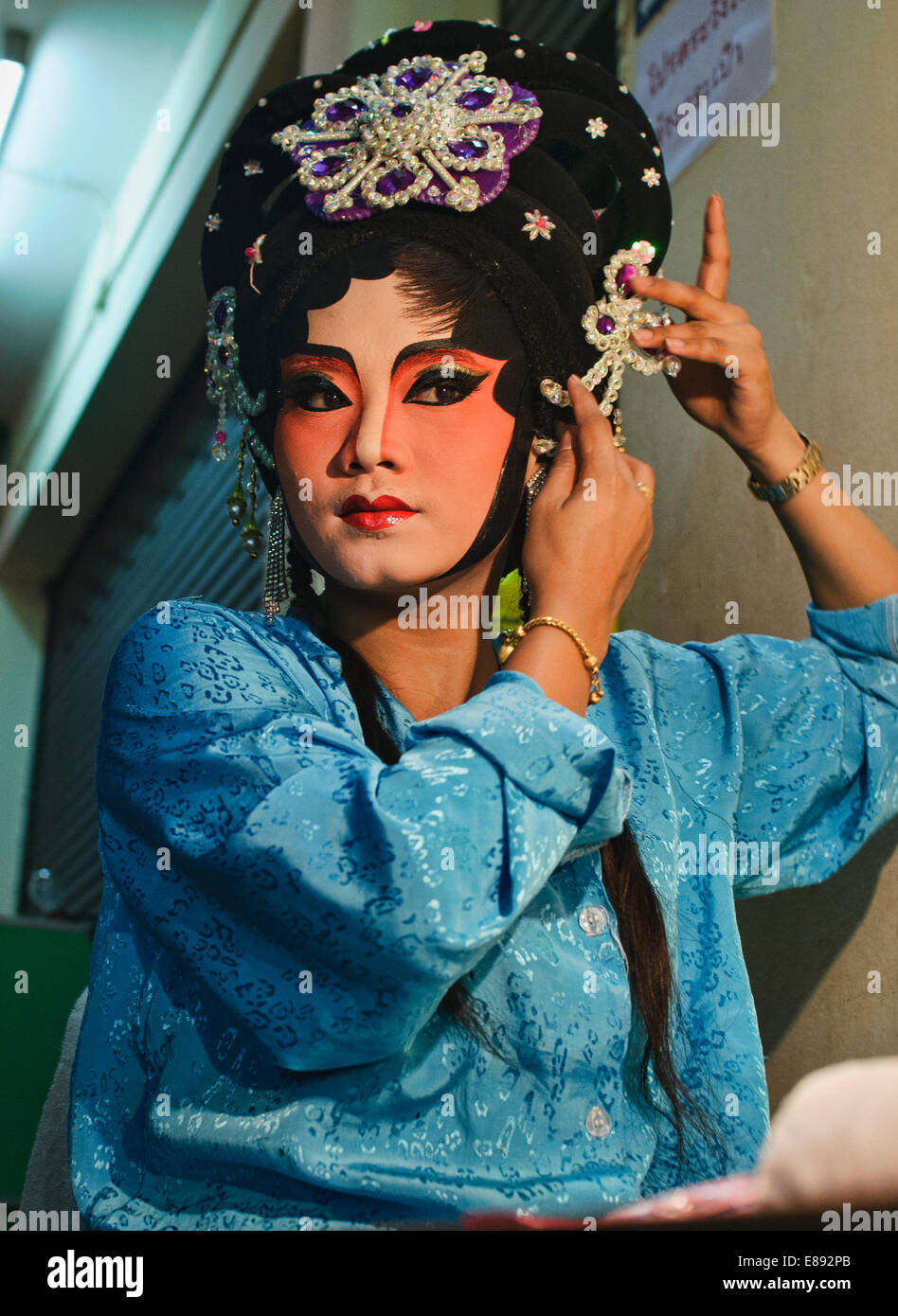 Chinese opera performer putting on her make-up at the Vegetarian ...