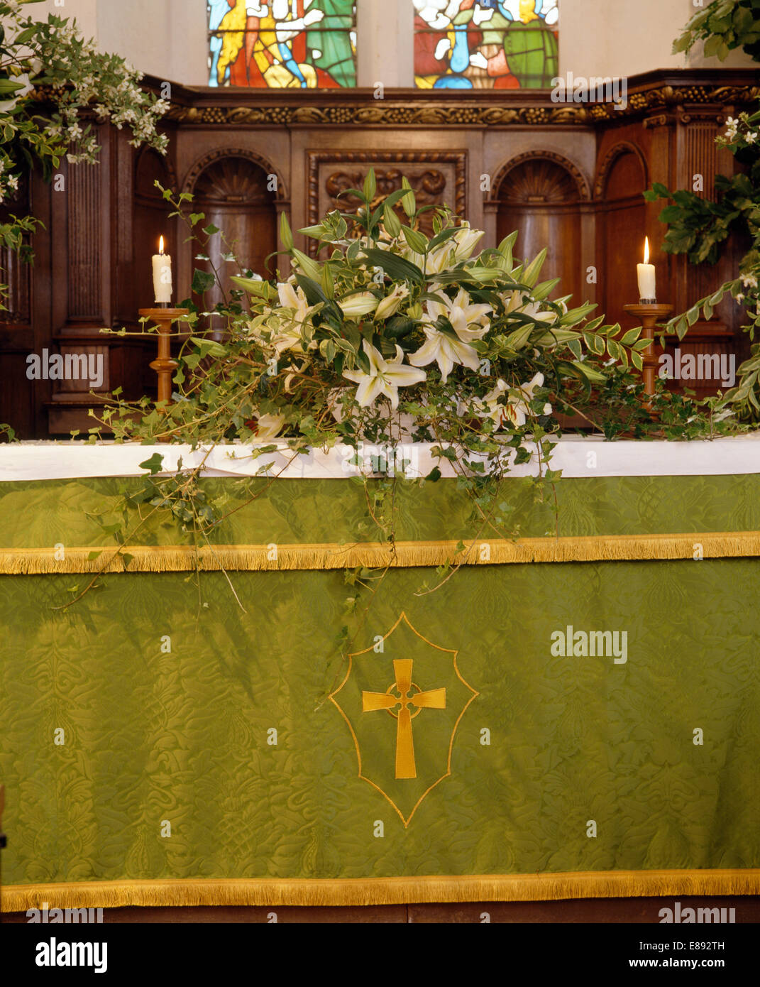 Floral arrangement of white lilies on altar of country church decorated ...