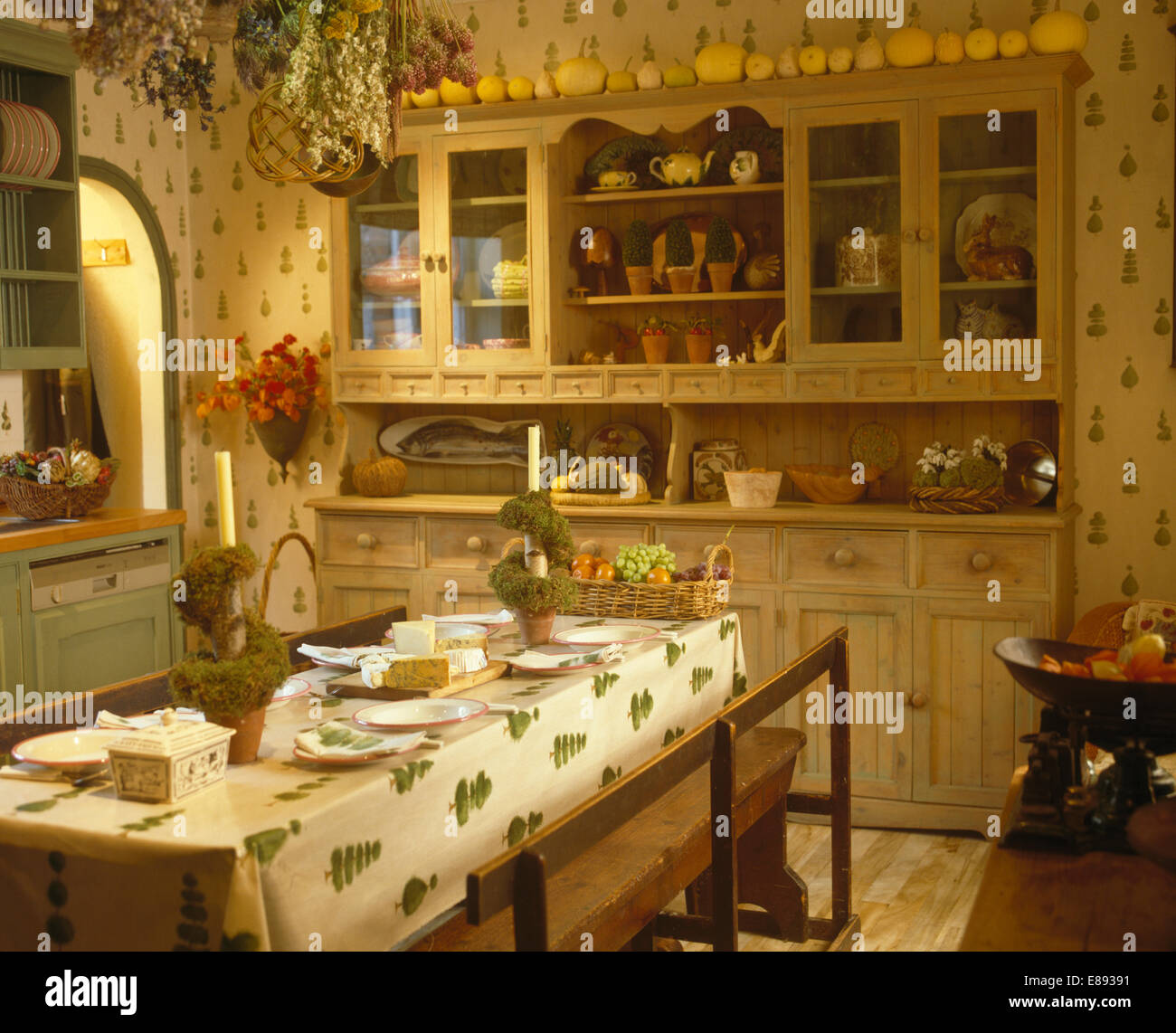 Green topiary tree cloth on table in country kitchen with large painted ...