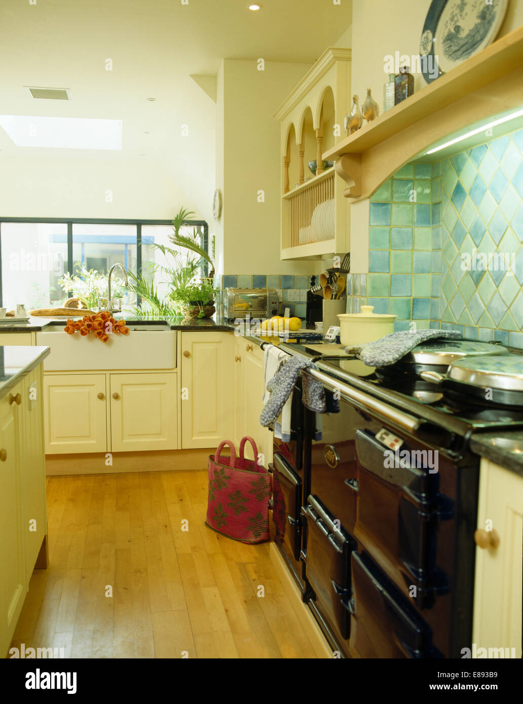 Black Aga oven in cream country kitchen with wooden flooring Stock ...