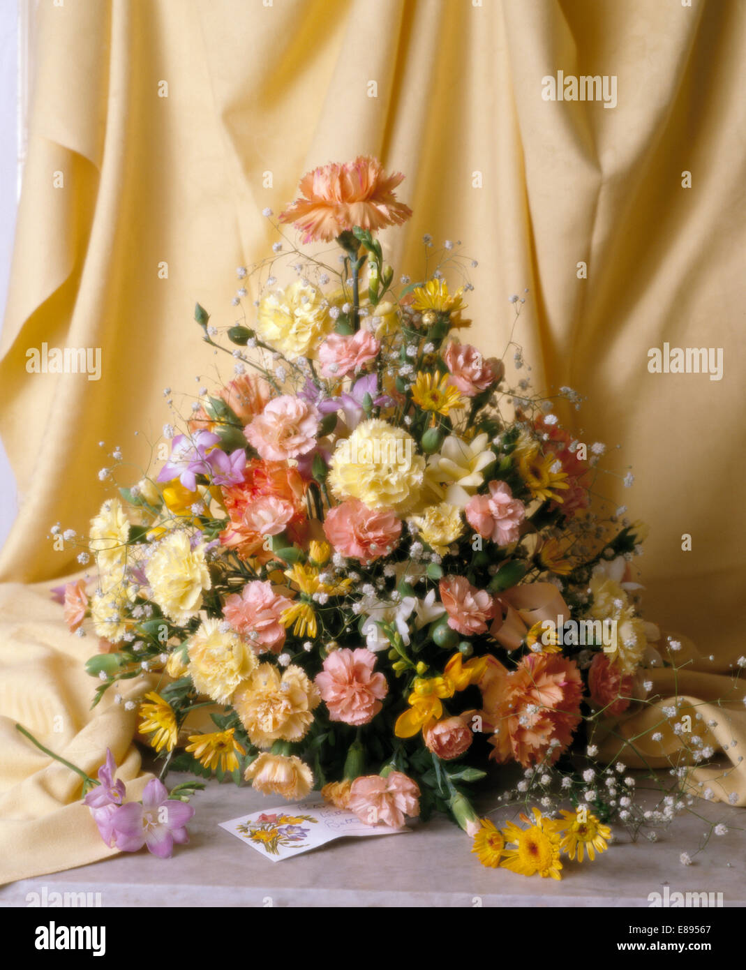 Still-Life of pink and pale yellow carnations in formal floral ...