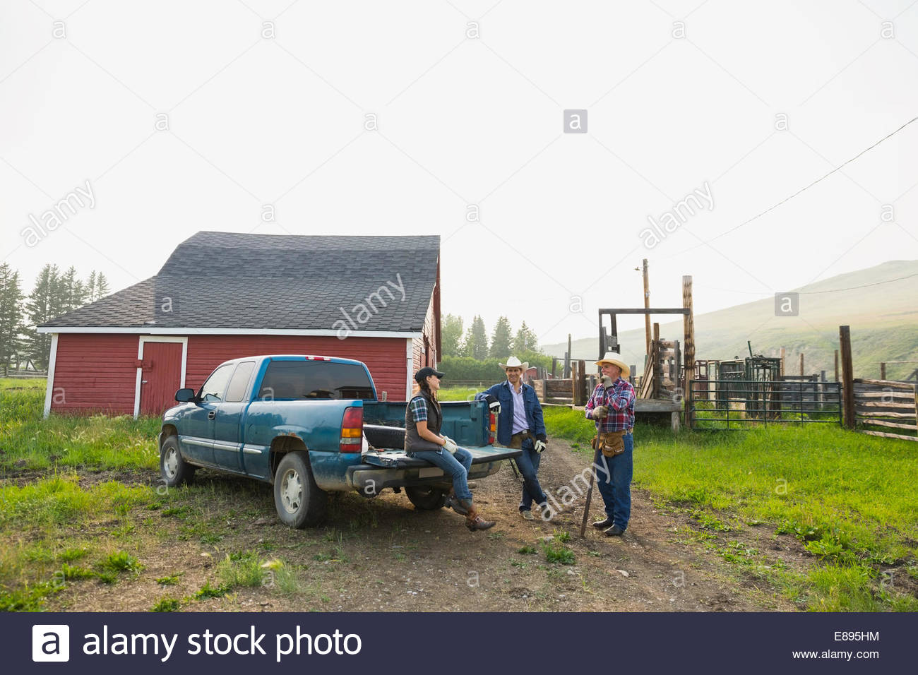 Ranchers talking at truck outside barn Stock Photo - Alamy