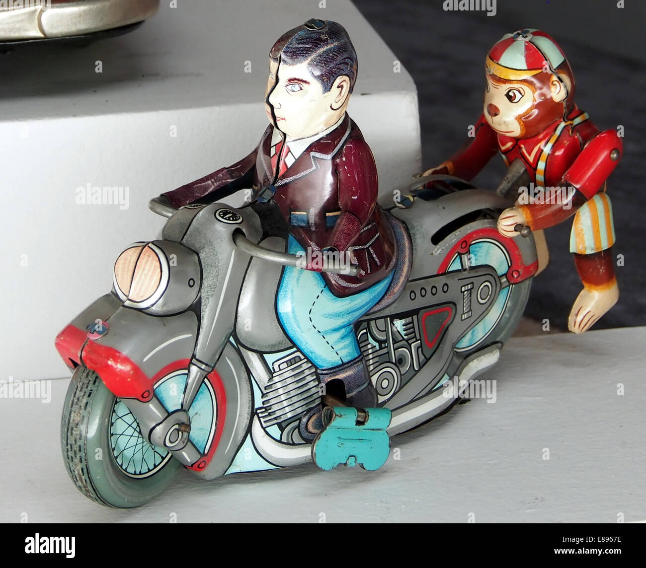 A tin toy motorcycle featuring a monkey rider, displayed at the Musée ...