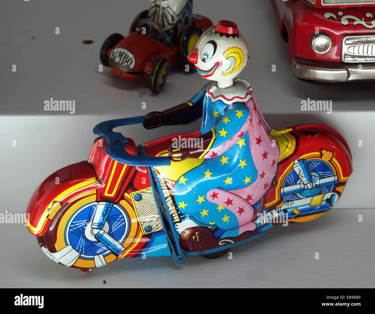 A tin toy clown on a motorcycle, displayed at the Musée du Jouet de ...