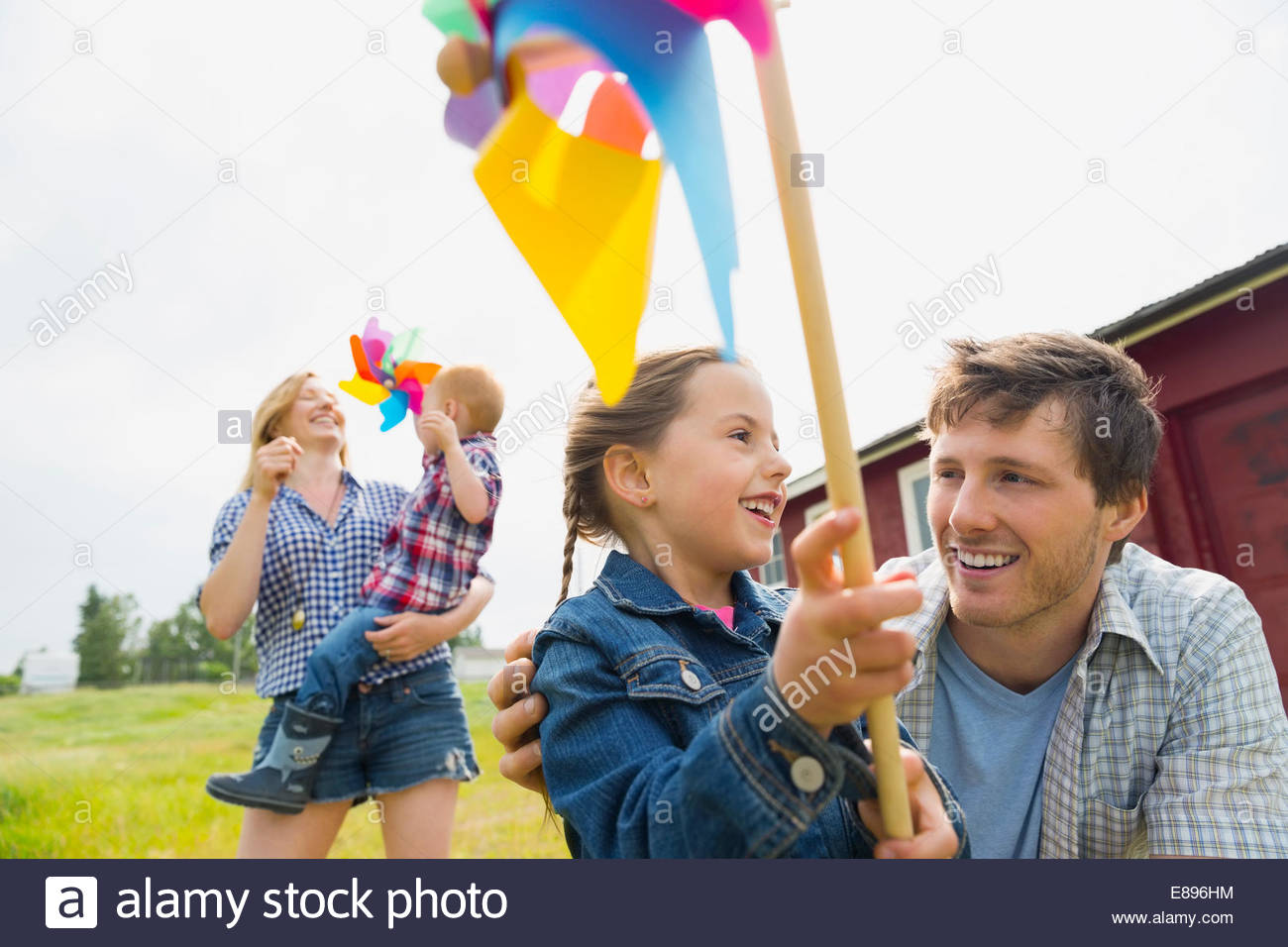 Parents with children holding pinwheels Stock Photo - Alamy