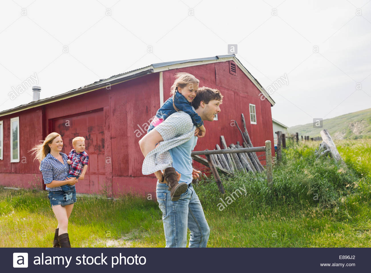 Parents carrying children outside Stock Photo - Alamy
