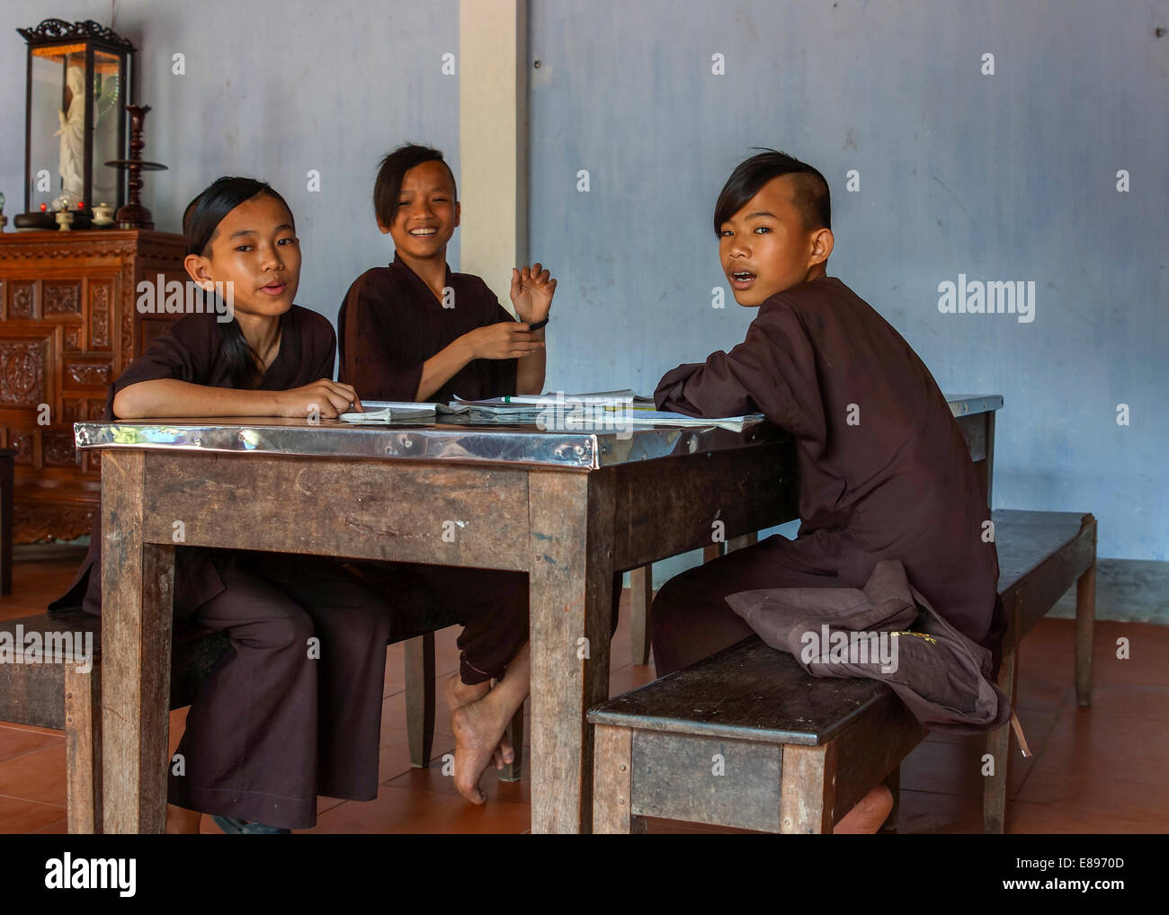 Three young boys monks studying in classroom at Royal Buddhist Thien Mu ...
